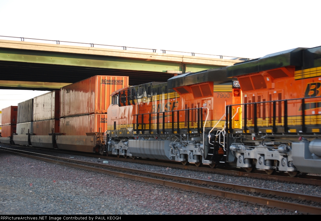 BNSF 7900 and the rear portion of BNSF 7902 roll west under the I-10 overcrossing as rear DPU ...